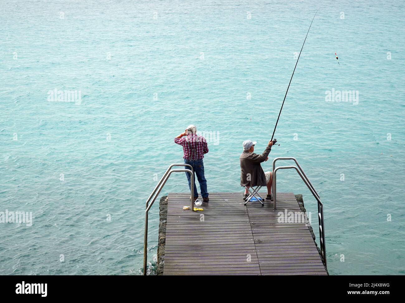 Fishermen fishing rod on pier hi-res stock photography and images - Alamy