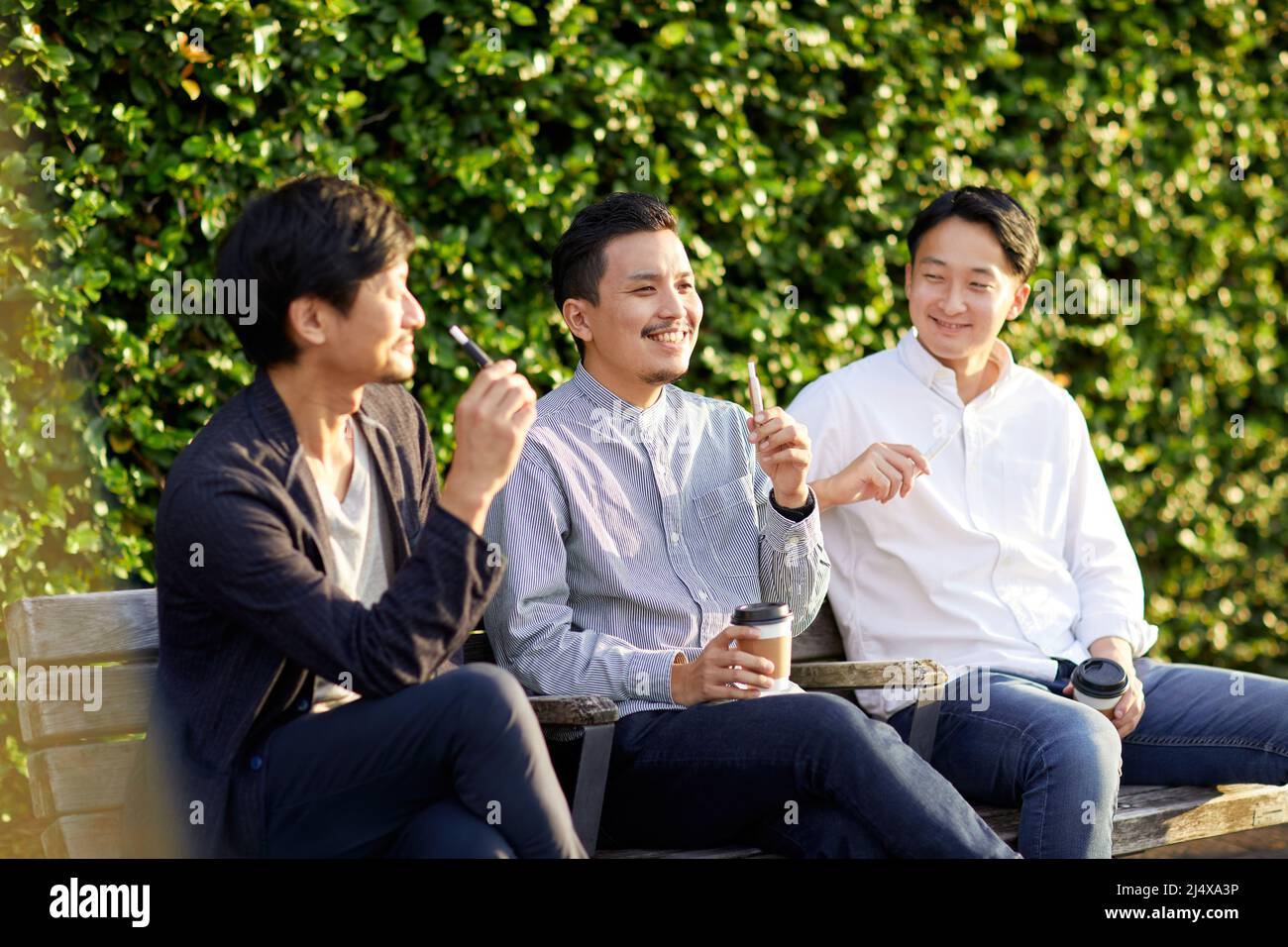 Japanese men smoking outside Stock Photo - Alamy