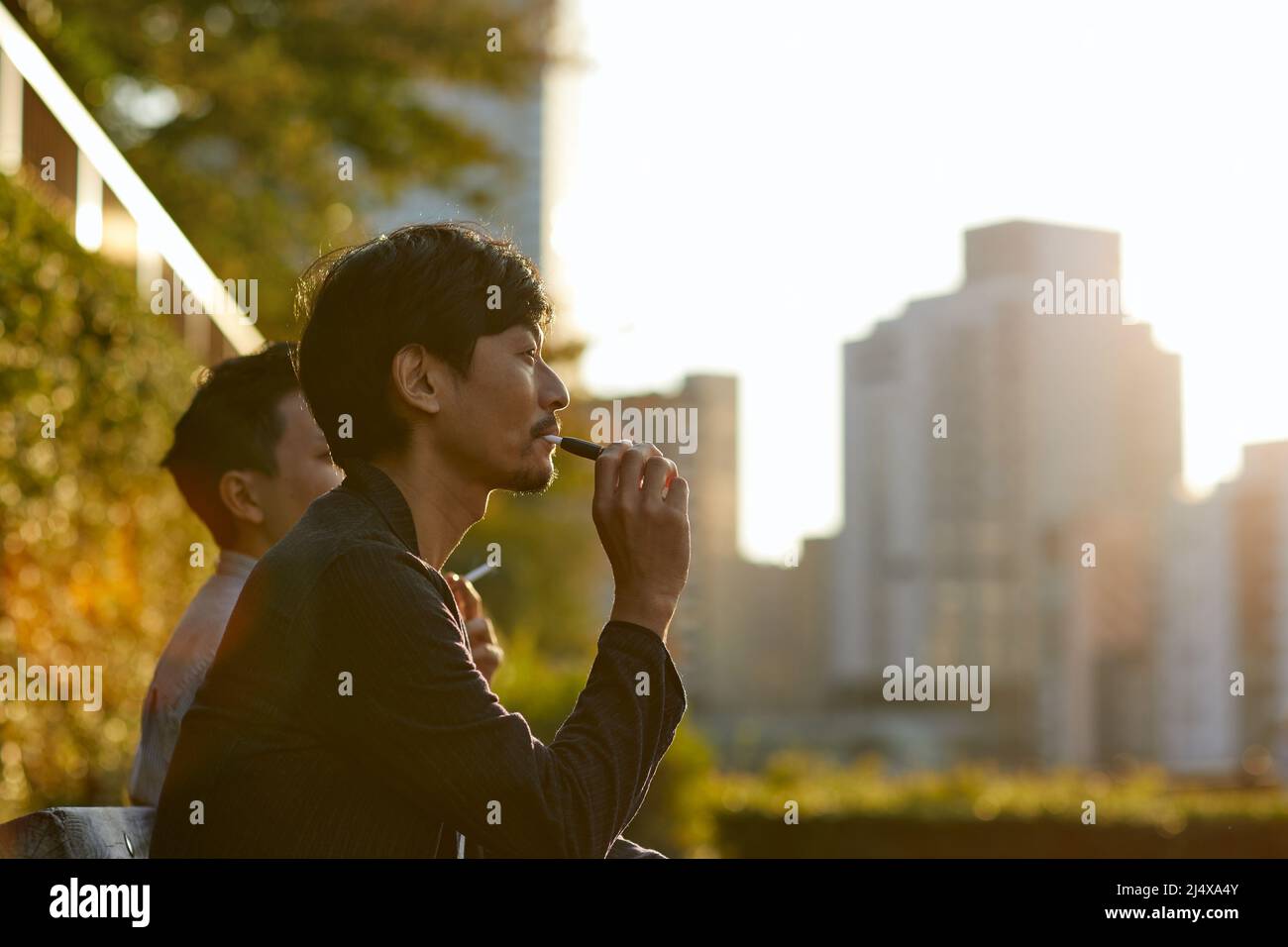 Japanese men smoking outside Stock Photo - Alamy