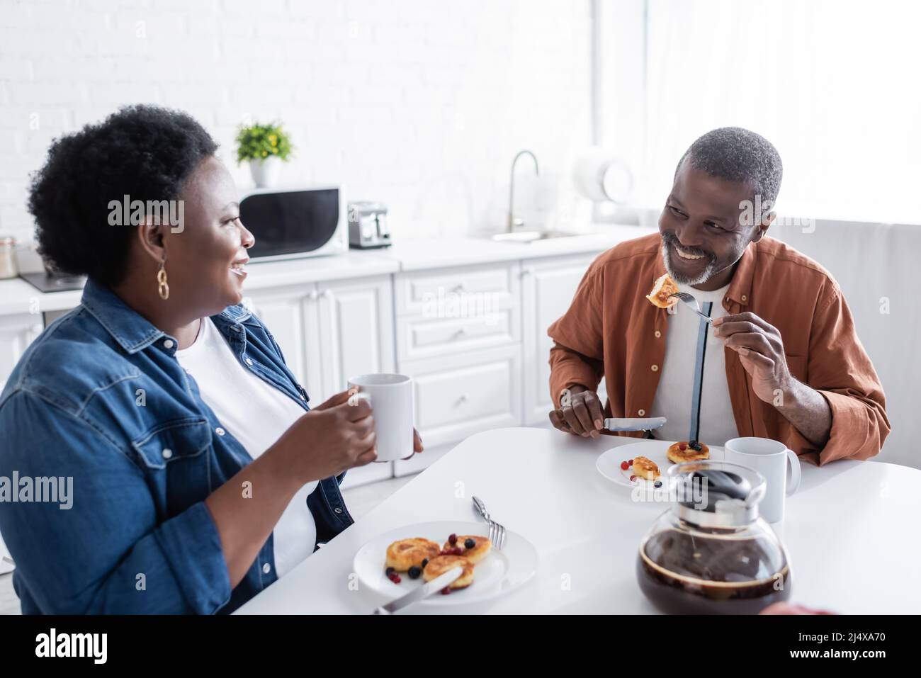 cheerful and senior african american couple having breakfast Stock ...
