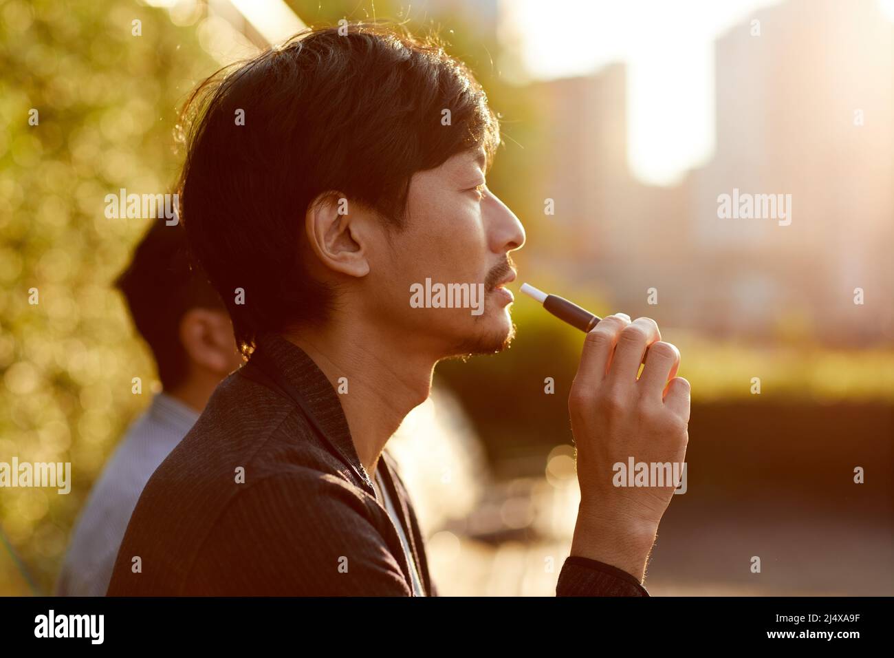 Japanese men smoking outside Stock Photo - Alamy