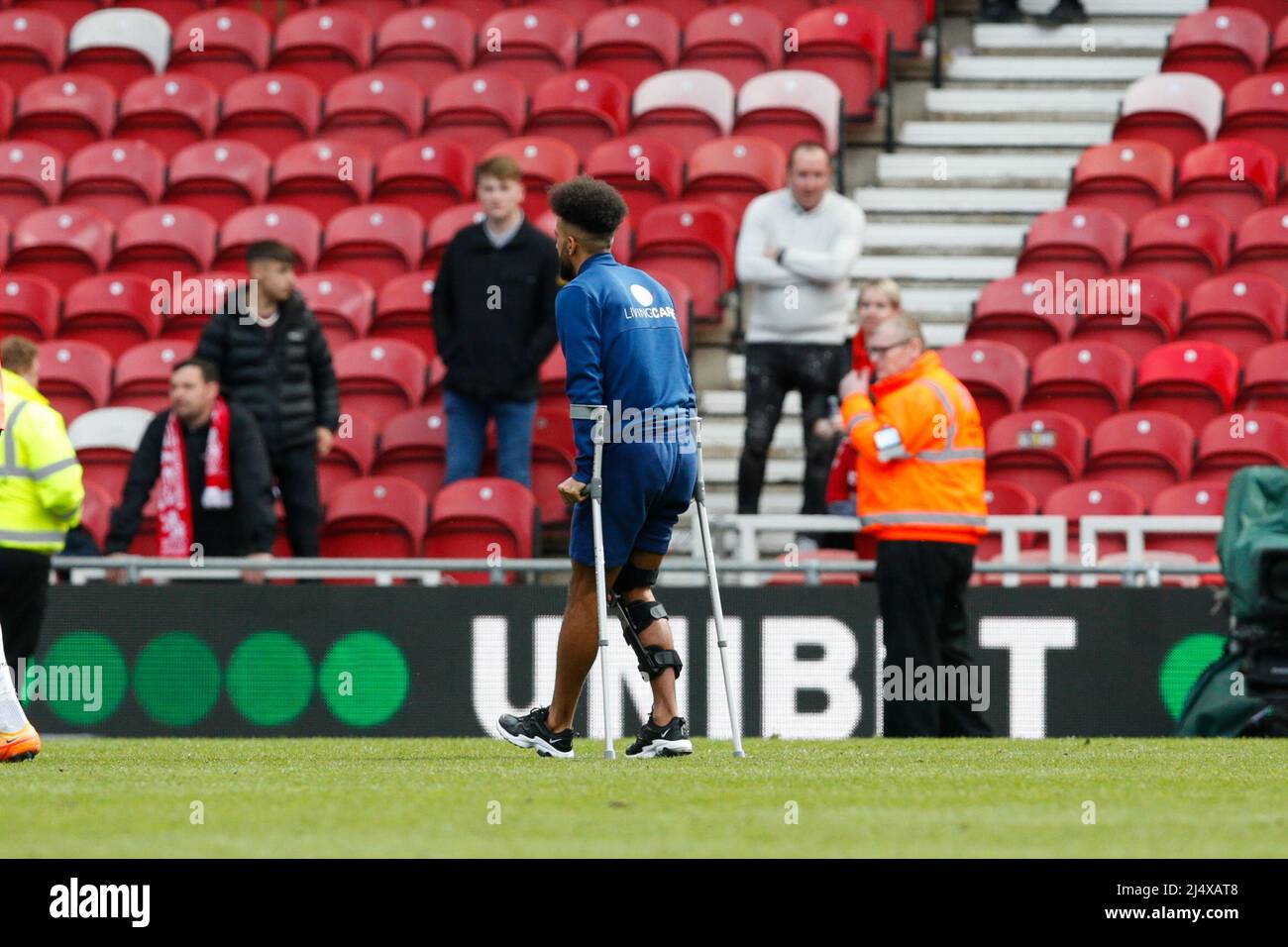 Sorba Thomas #16 of Huddersfield Town with a knee brace and using ...