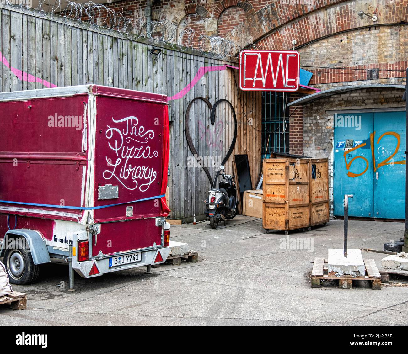 Fame restaurant sign & Pizza Library trailer next to railway viaduct in ...