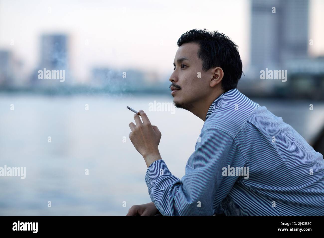 Side view man relaxing smoking hi-res stock photography and images - Alamy