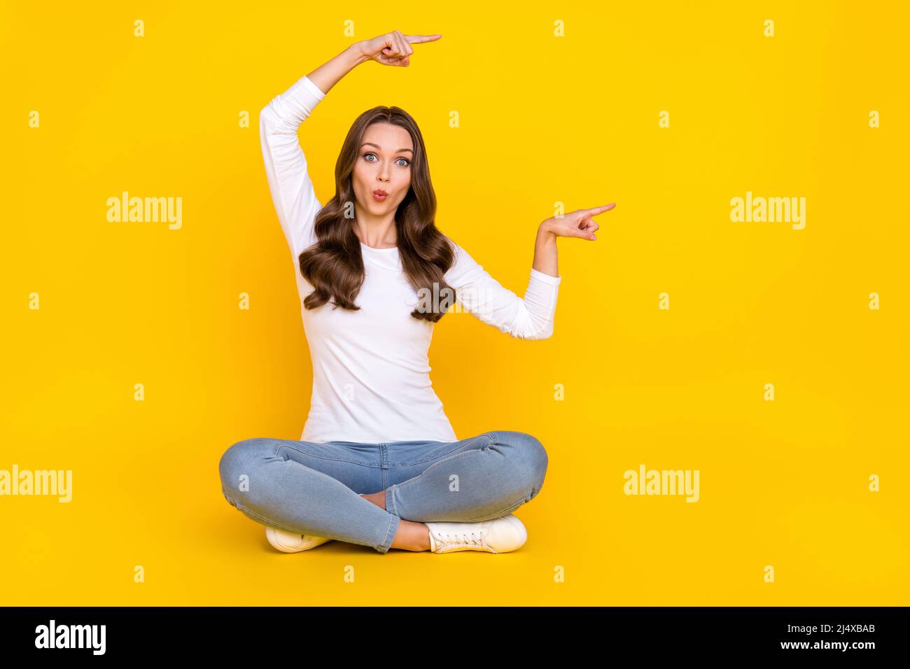 Photo of sweet impressed woman wear white shirt pointing empty space ...