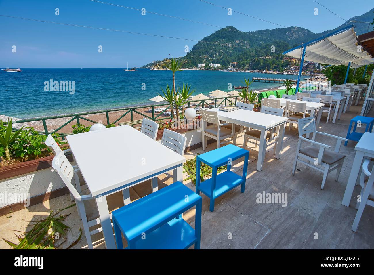 Traditional greek street cafe with flowers. Empty tables and chairs of ...