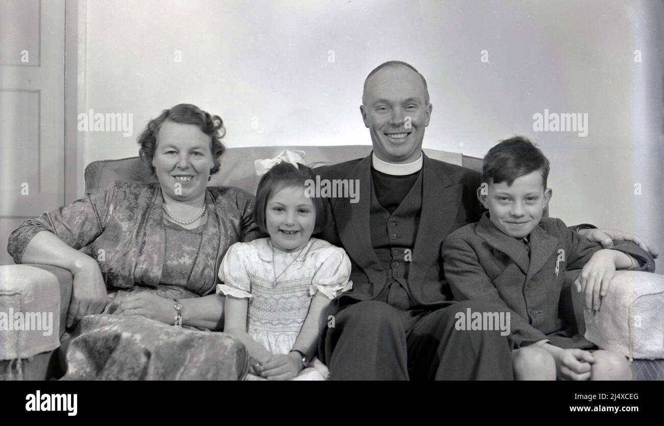 1950s, historical, seating together on the sofa for a happy family ...
