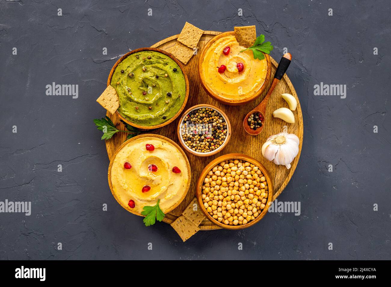 Flatlay of different types of colorful hummus in bowls. Vegan food ...