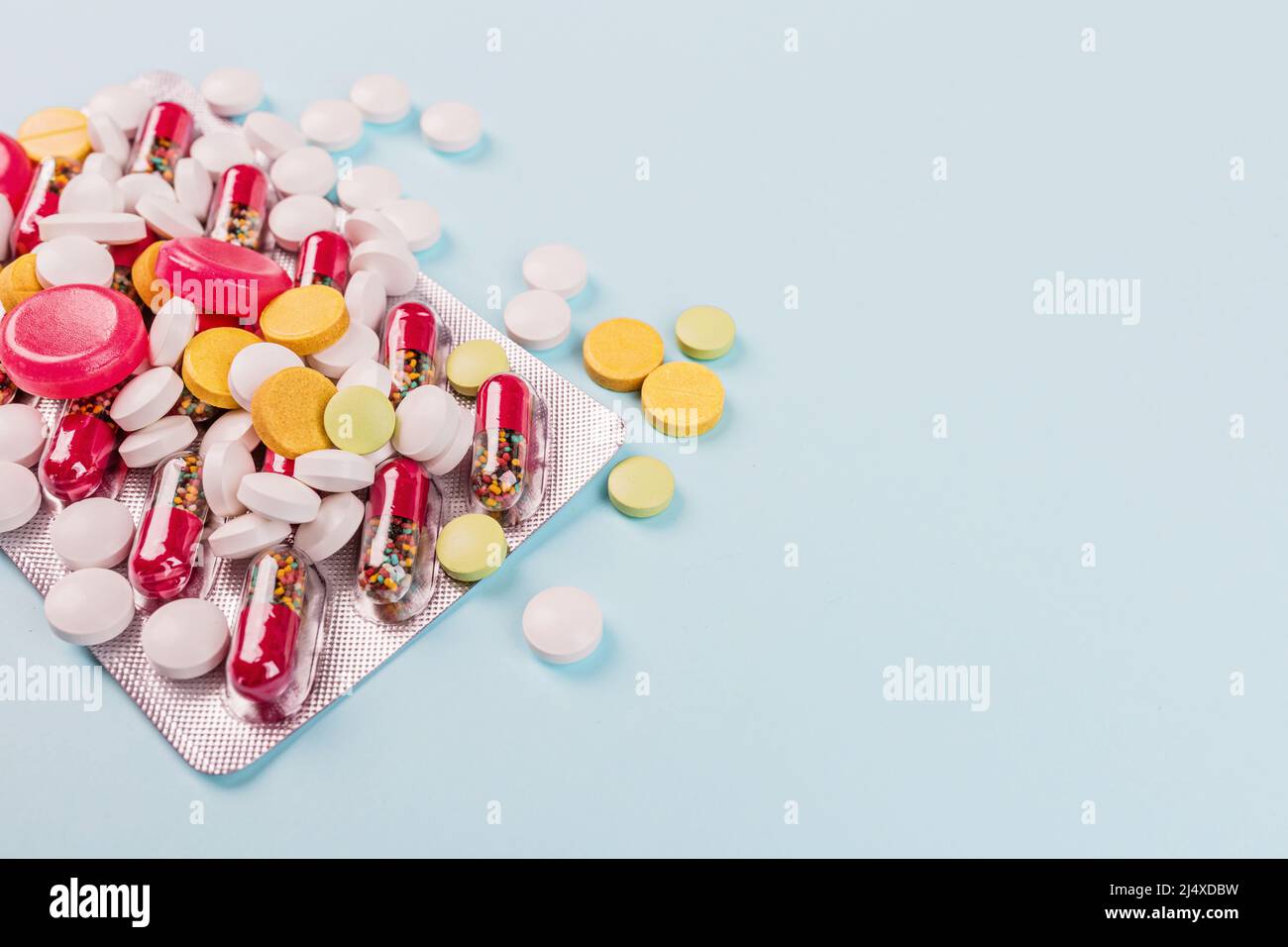 Colorful pills on a pastel blue background. Flat lay, top view ...