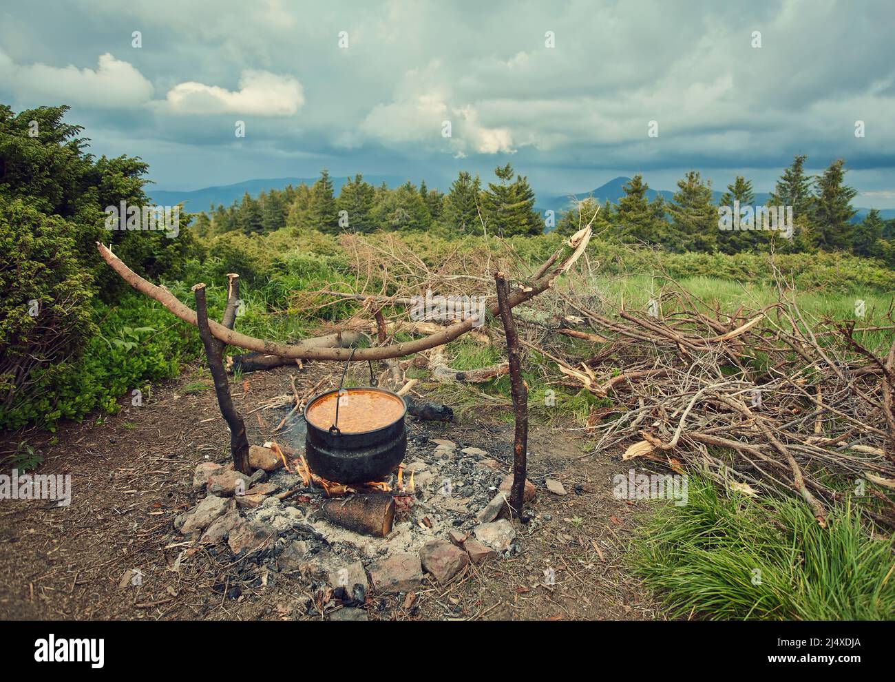 Cooking breakfast on fire in mountains. Camping season Stock Photo - Alamy
