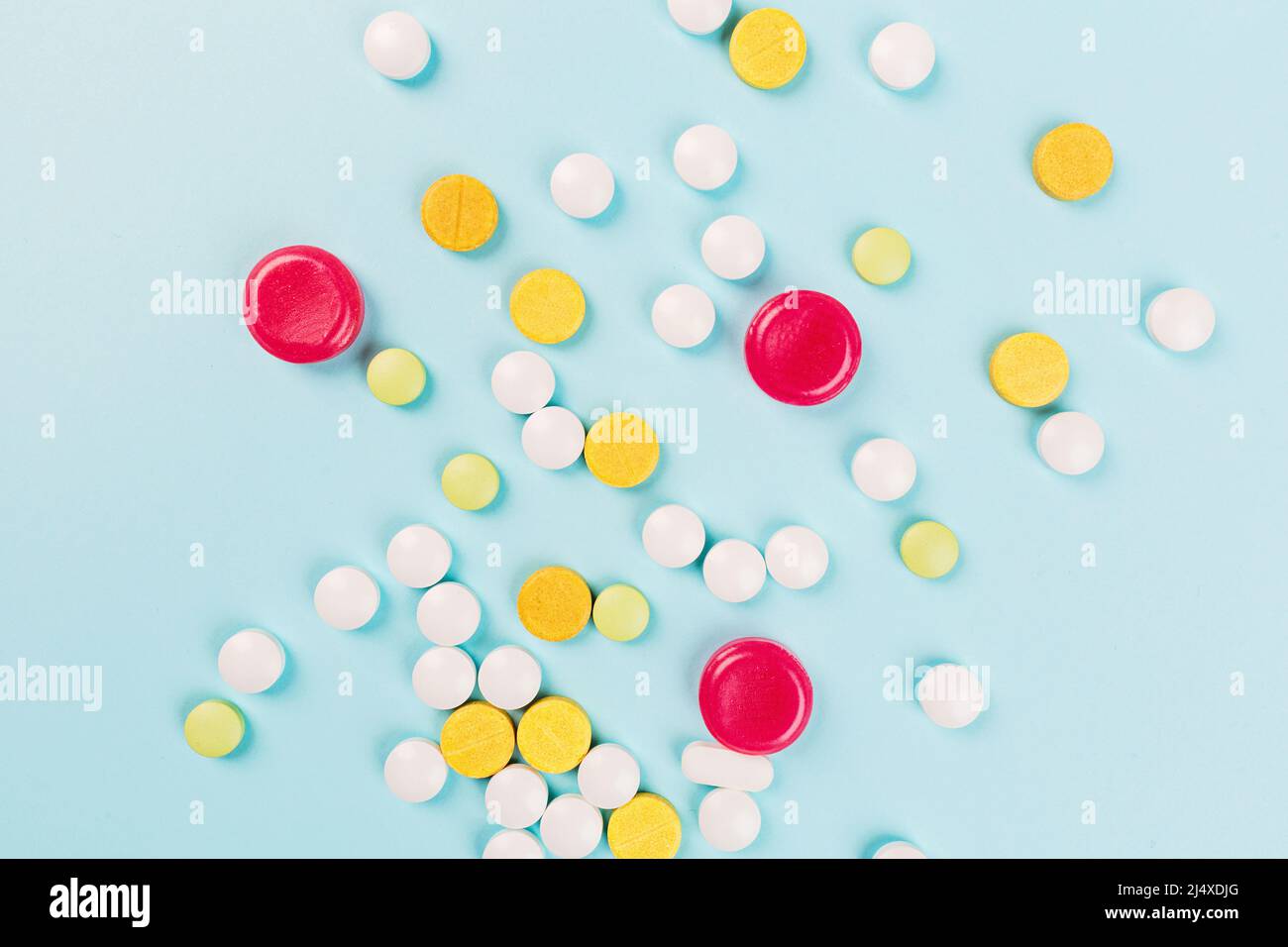 Colorful pills on a pastel blue background. Flat lay, top view ...