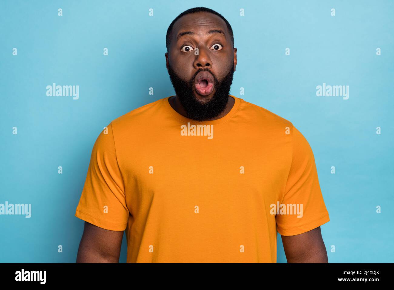 Photo of impressed funny guy dressed orange t-shirt big eyes open mouth ...