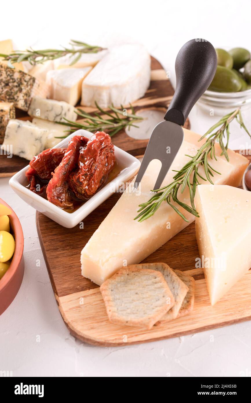 Solid and soft-ripened cheeses. Charcuterie board with cheese slices ...