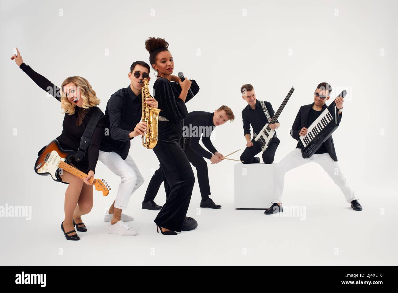 Portrait of diverse group of young people musical band playing with ...