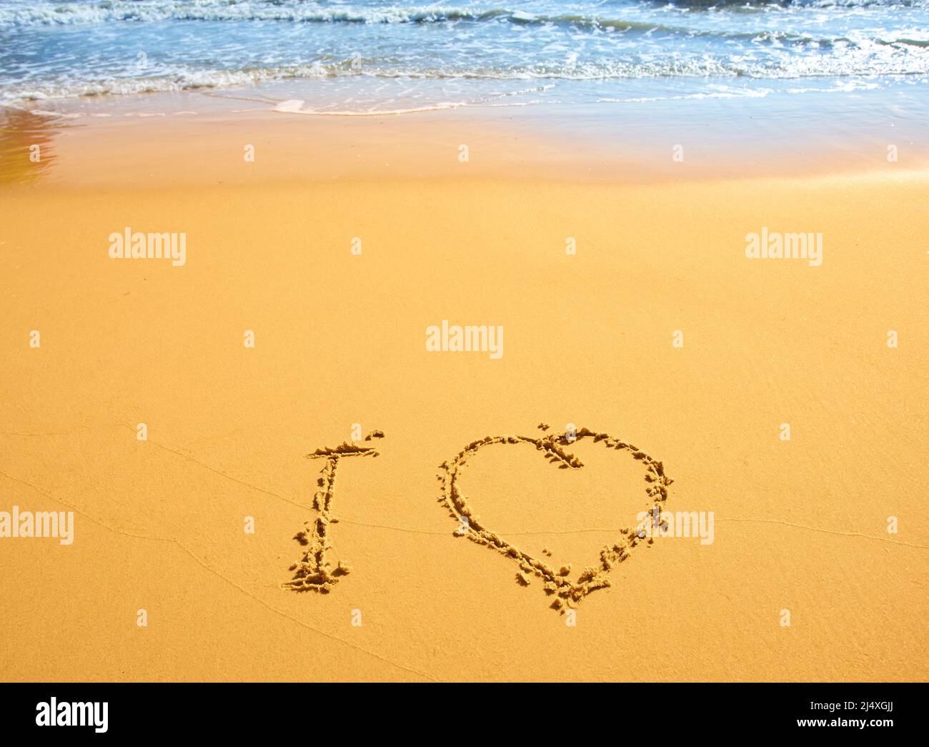 Heart drawn in the sand of sea beach Stock Photo - Alamy