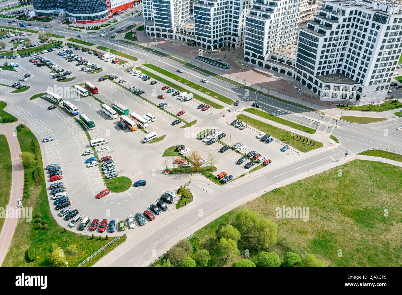 aerial view of large parking lot with cars and buses in city ...