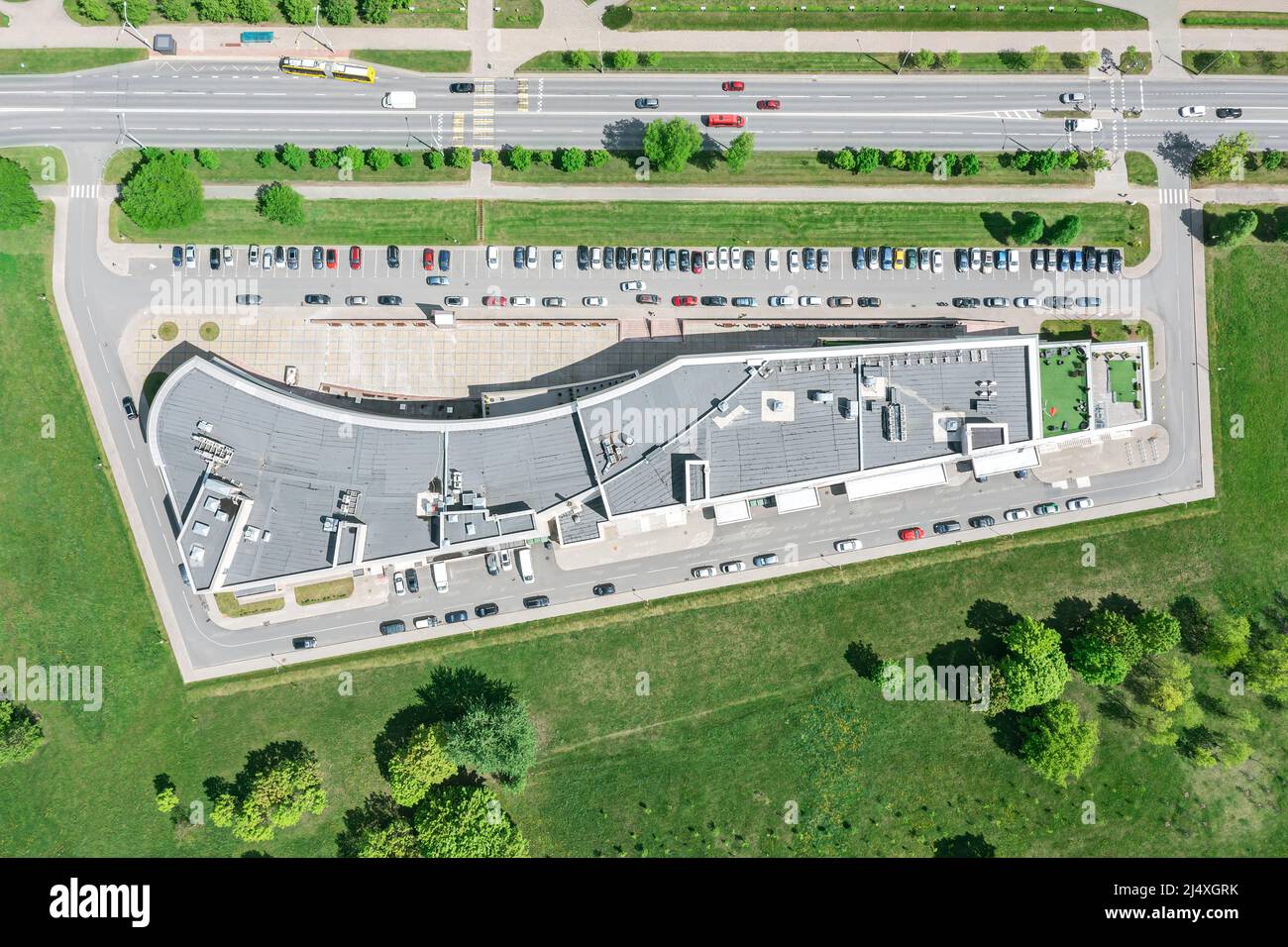 modern office building in urban area. parking lot with parked cars ...