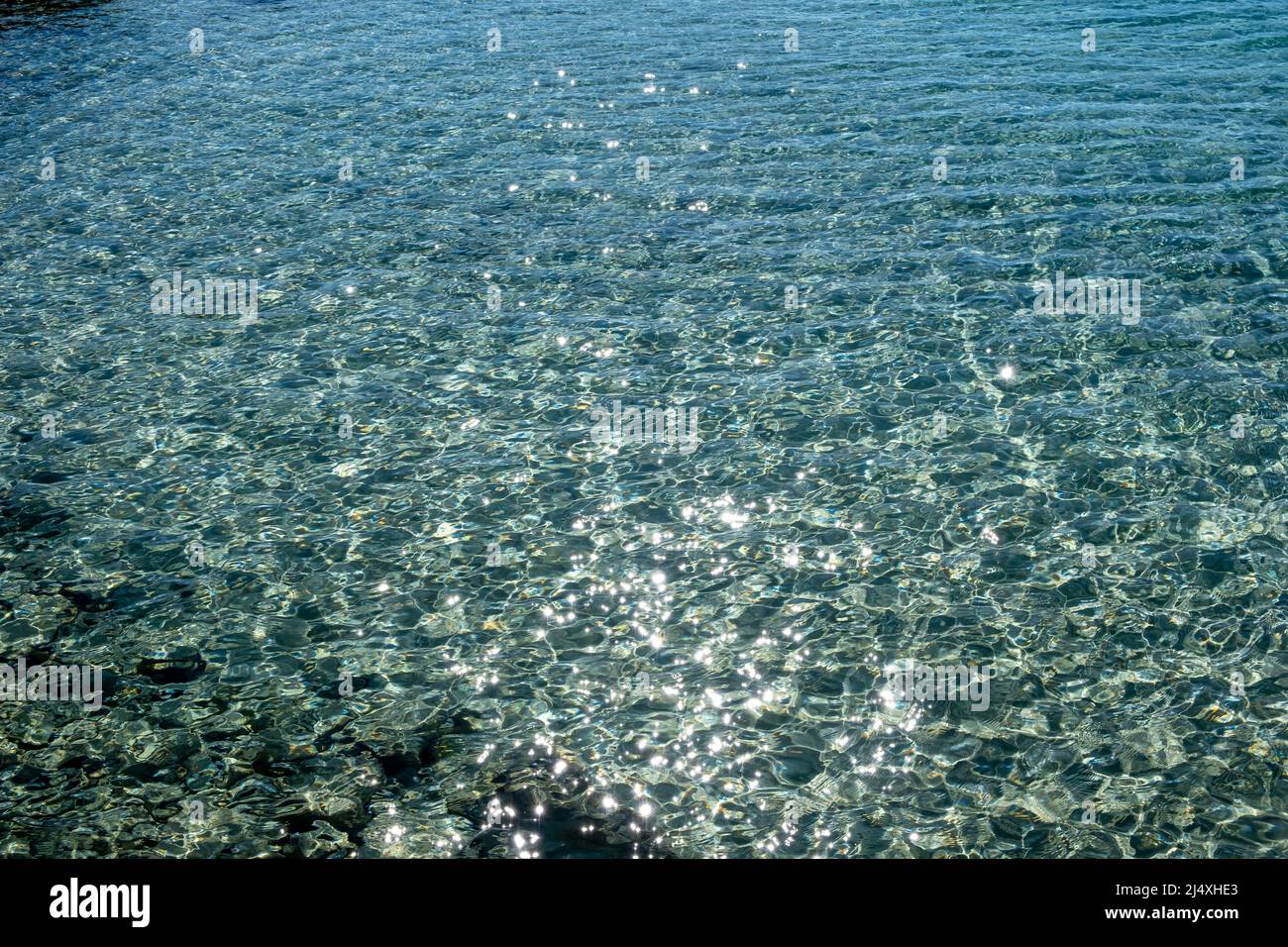 Sea water surface with shiny reflections background. Clear crystal ...