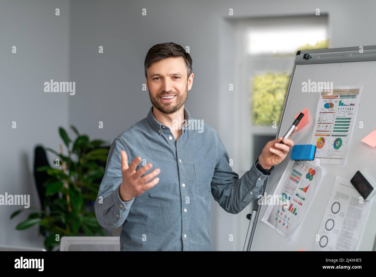 Business opportunities. Confident middle aged man making presentation ...