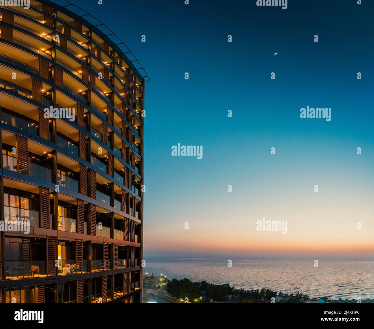 Rising moon above Hotel On Persian Gulf Coast In Evening Night. Urban ...