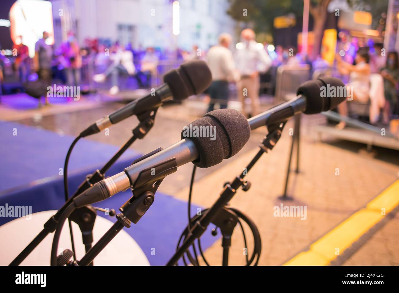 three microphones ready at a seminar event Stock Photo - Alamy