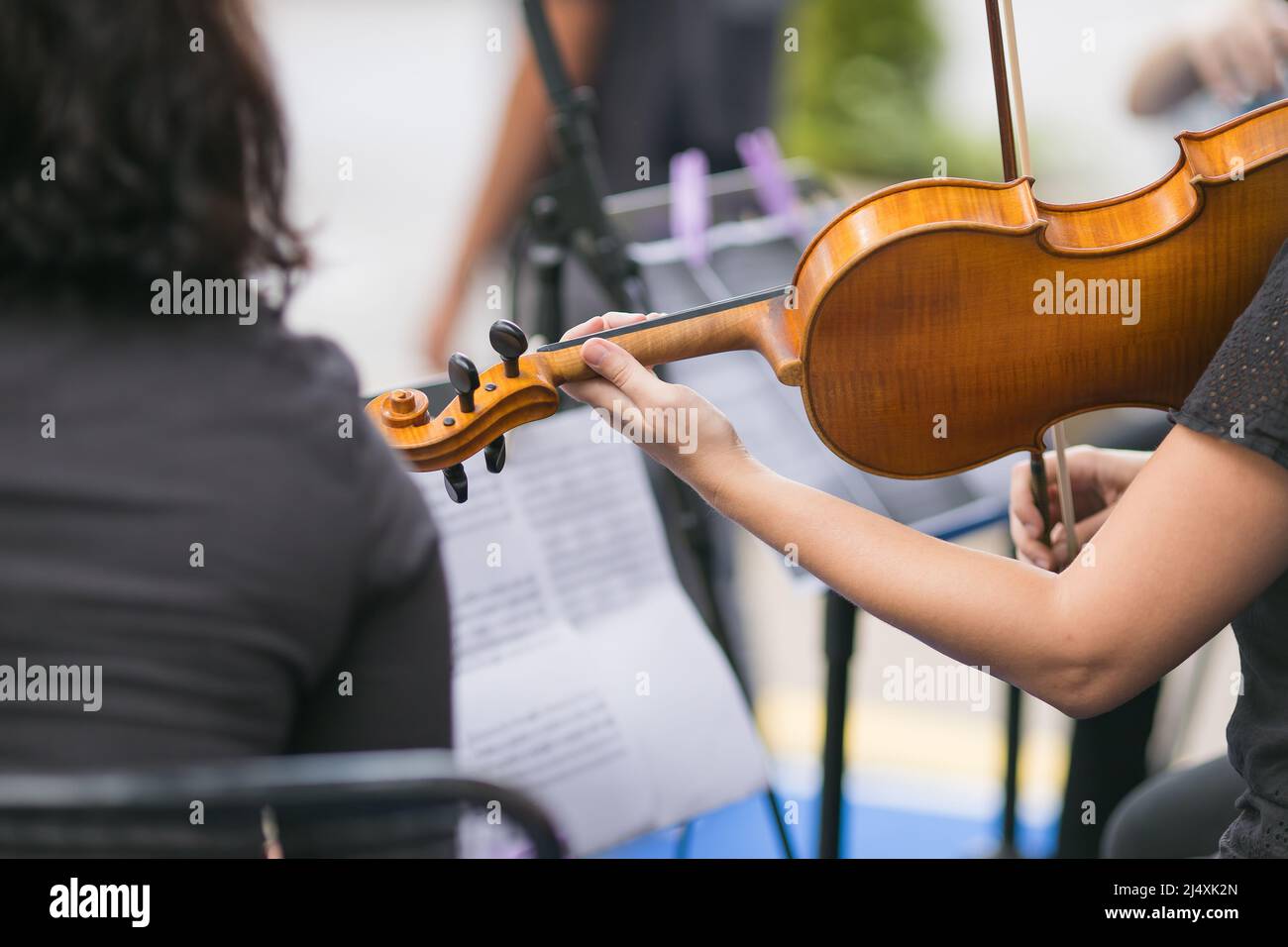 detail of a string orchestra playing a concert Stock Photo - Alamy
