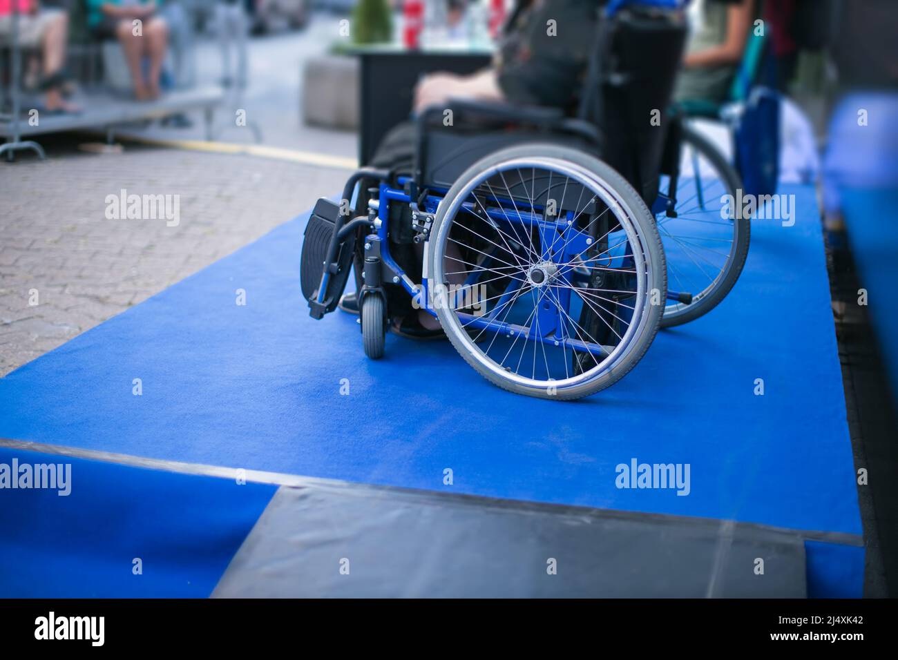 performer on handicap chair on podium next to access ramp Stock Photo ...
