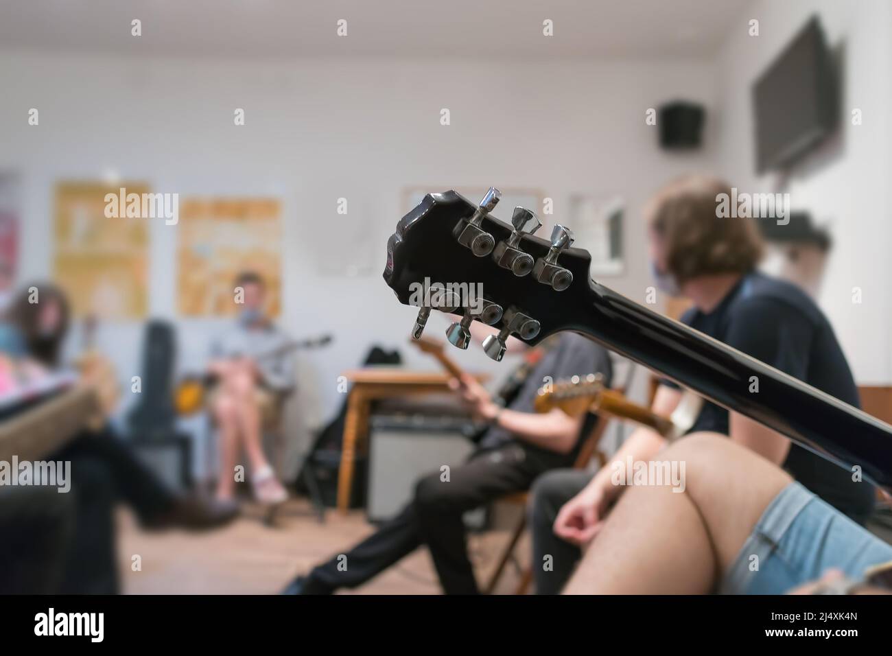 playing guitar at group guitar lesson Stock Photo - Alamy