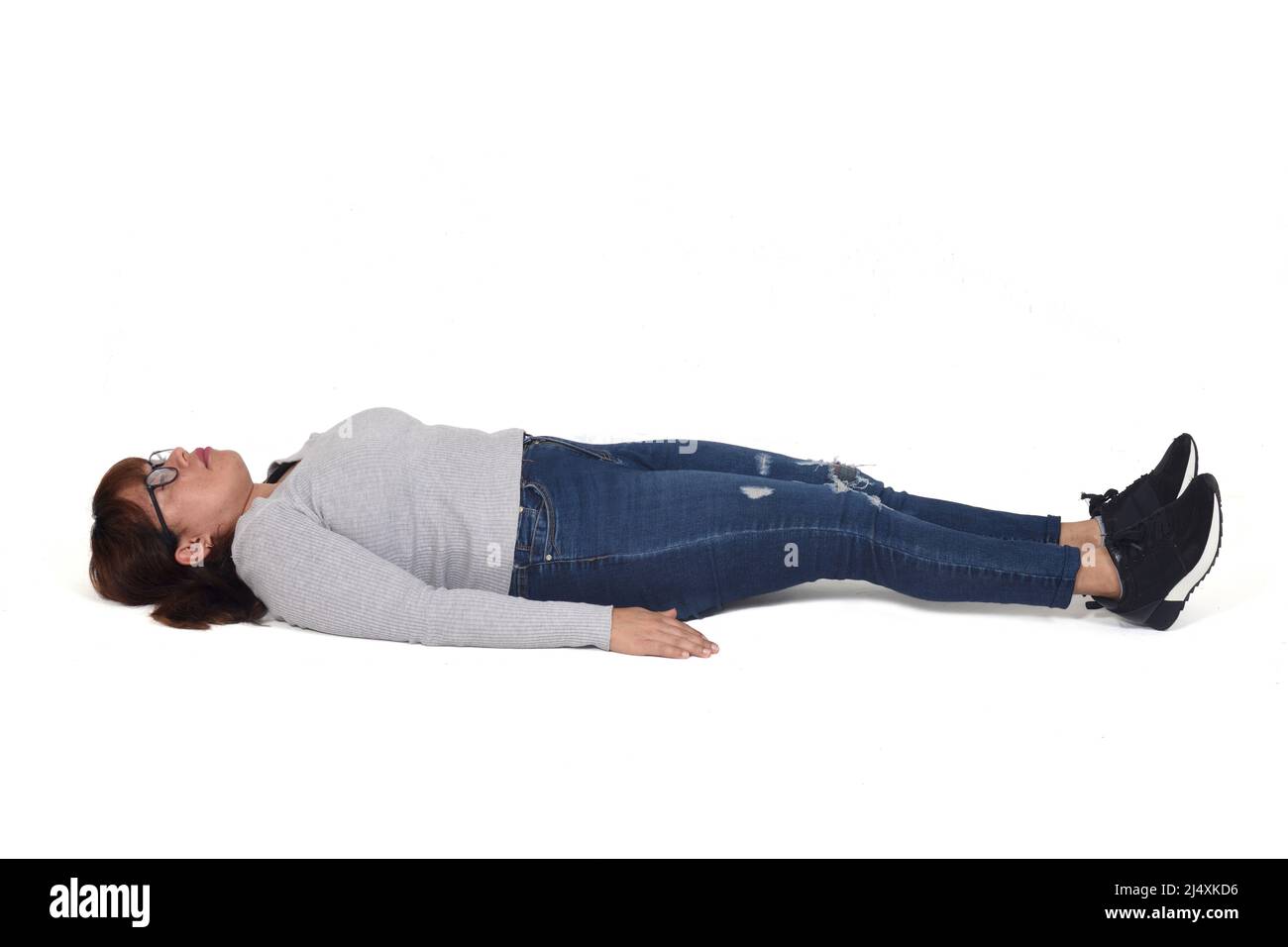 woman lying on the floor on white background Stock Photo - Alamy