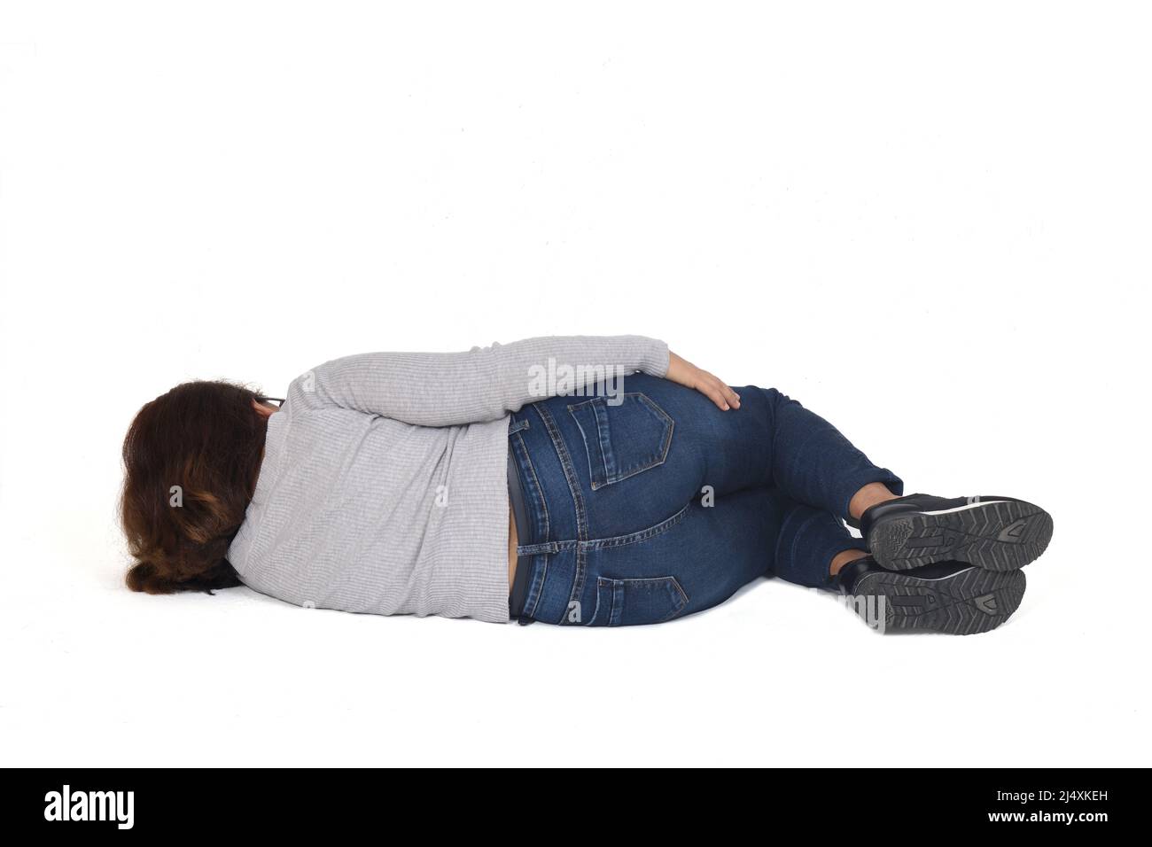 rear view of a woman lying on the floor on white background Stock Photo ...