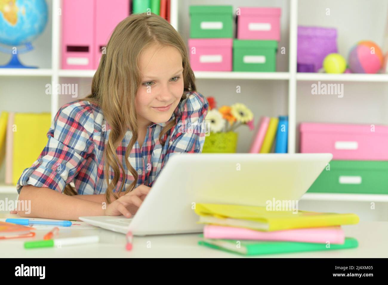 Beautiful young girl with laptop studying Stock Photo - Alamy