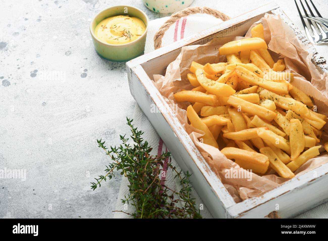 French fries. Tasty French fries server on parchment paper on wooden ...