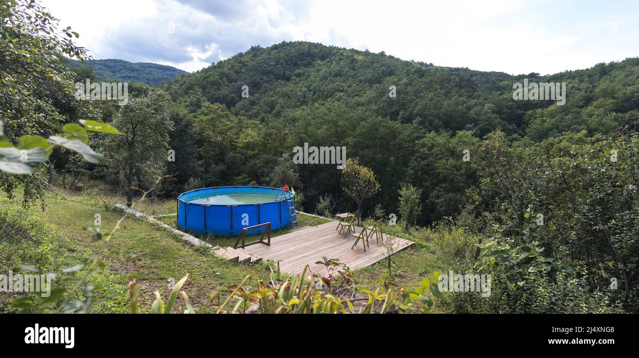 above ground swimming pool in the garden Stock Photo - Alamy