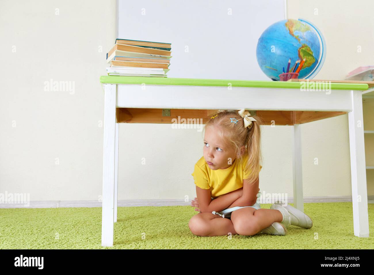 Girl hiding at table hi-res stock photography and images - Alamy