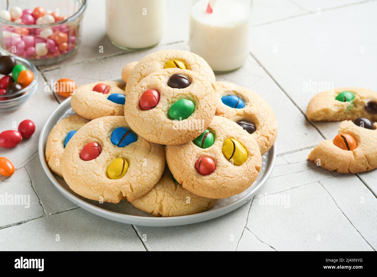 Homemade cookies with colorful chocolate candies and milk. Stack of ...