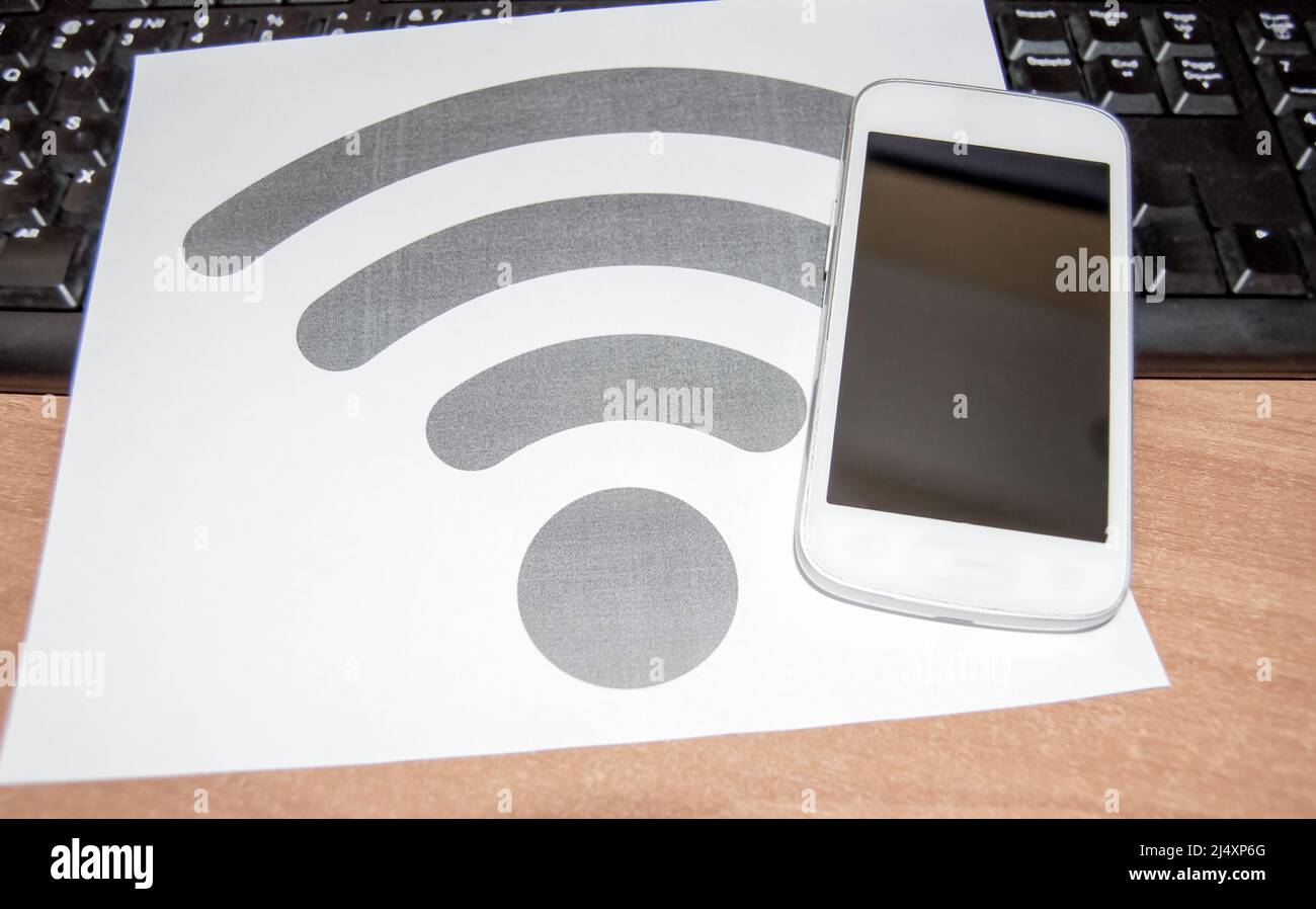 Wi-Fi symbol on a piece of paper near the computer keyboard and mobile ...