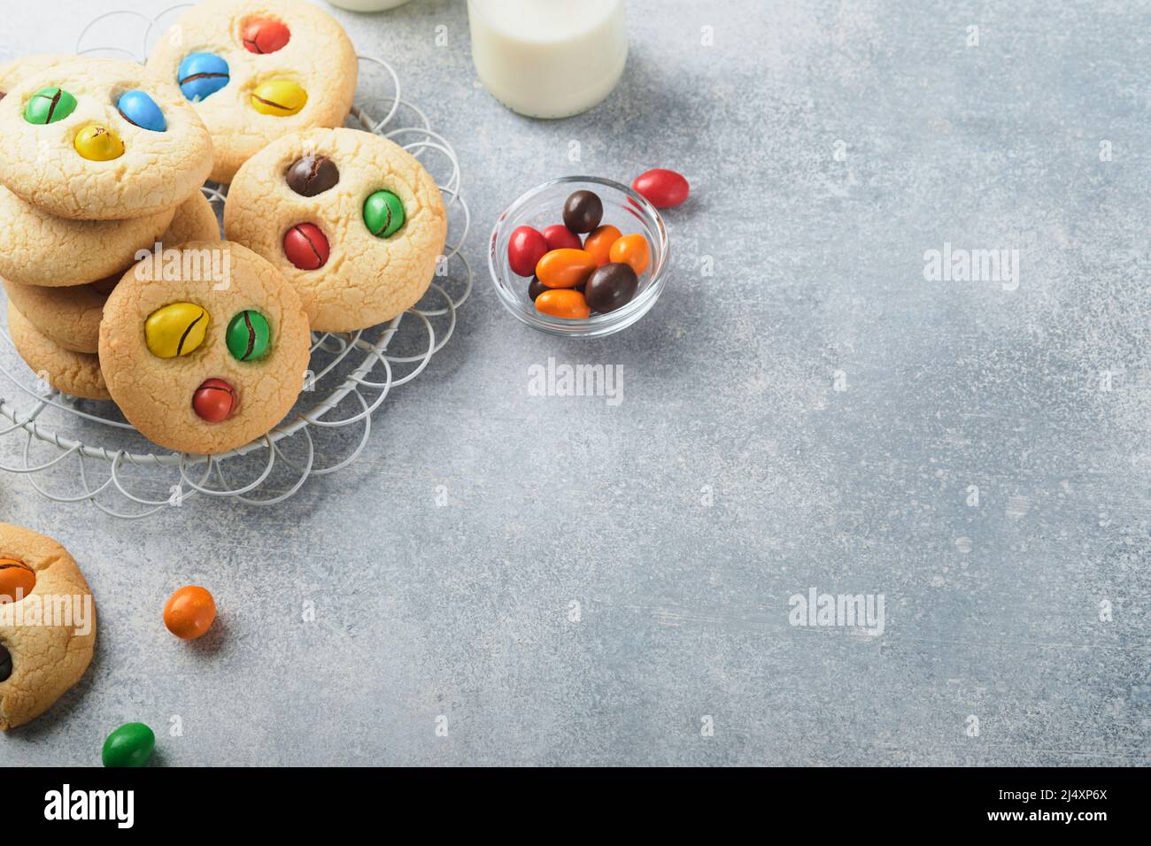 Homemade cookies with colorful chocolate candies and milk. Stack of ...
