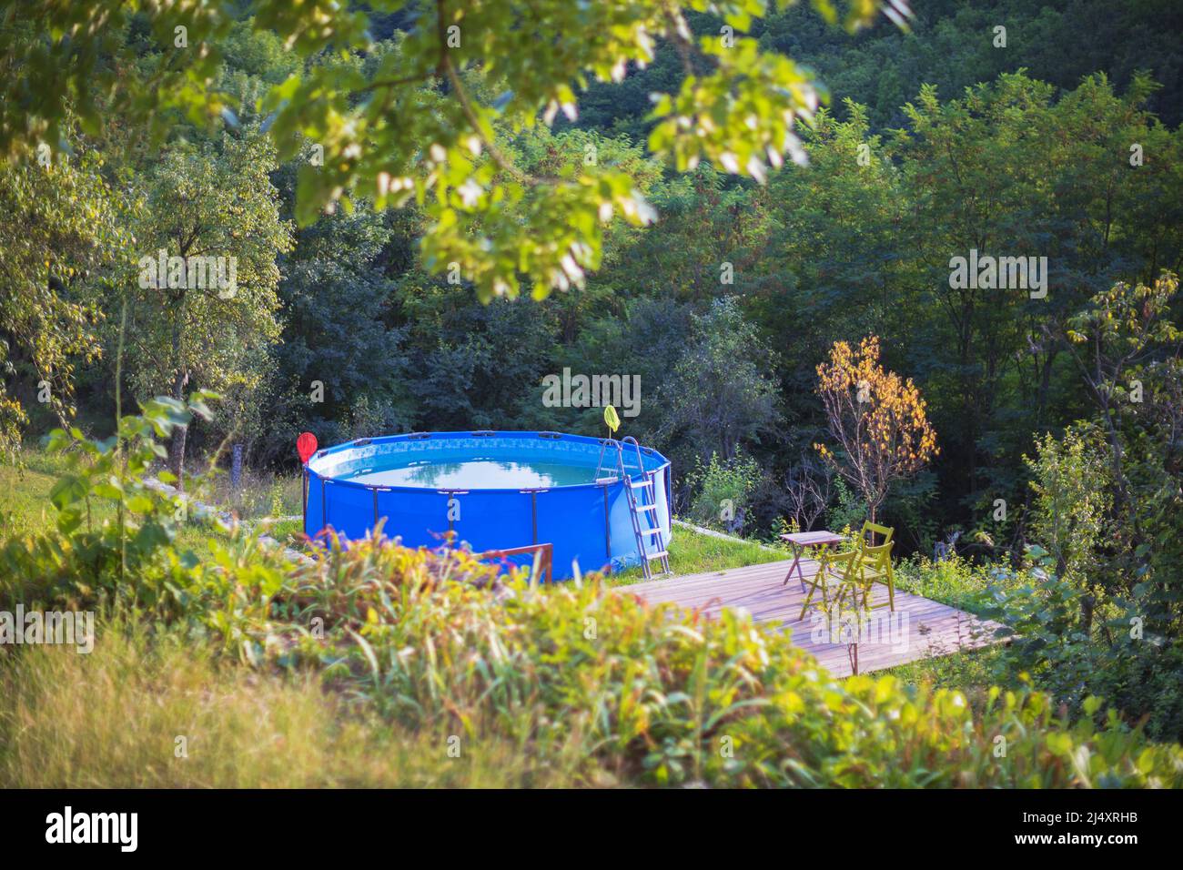 above ground swimming pool in the garden Stock Photo - Alamy