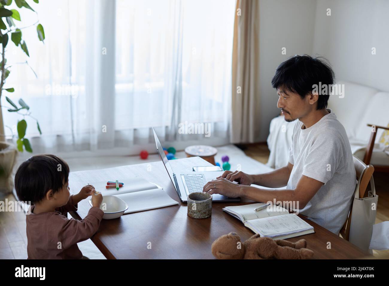 Japanese man working from home with kid Stock Photo - Alamy