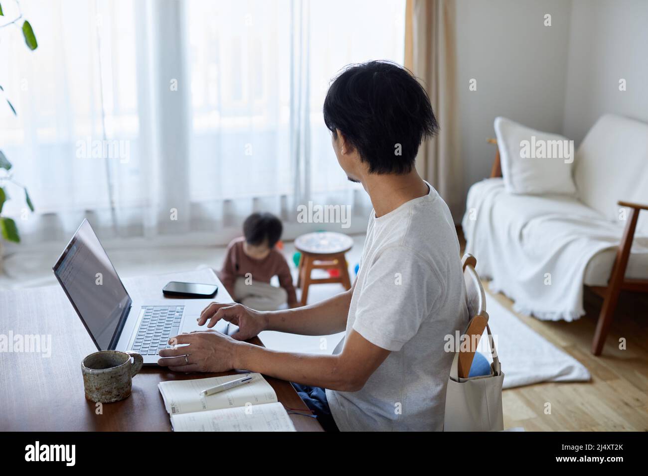 Japanese man working from home with kid Stock Photo - Alamy