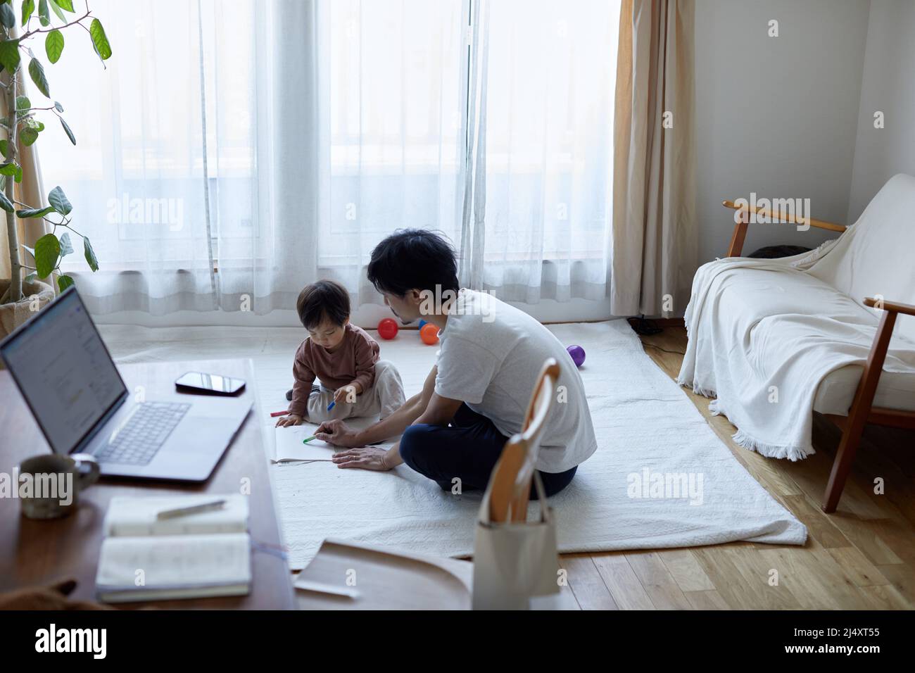 Japanese man working from home with kid Stock Photo - Alamy