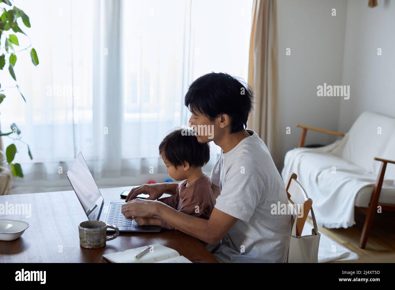 Japanese man working from home with kid Stock Photo - Alamy