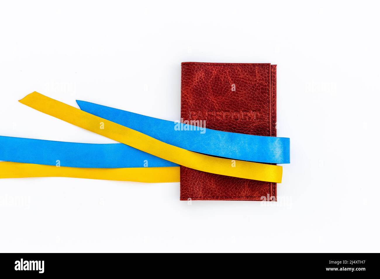 Ukrainian immigration concept - yellow and blue ribbon on passport ...