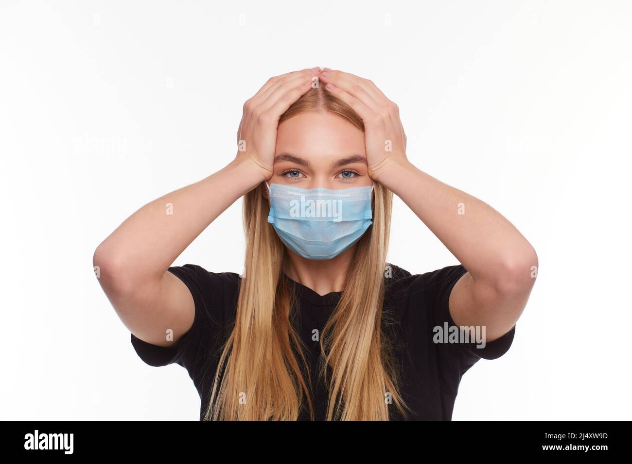 Studio portrait of young blonde illness girl with closed eyes, wearing ...