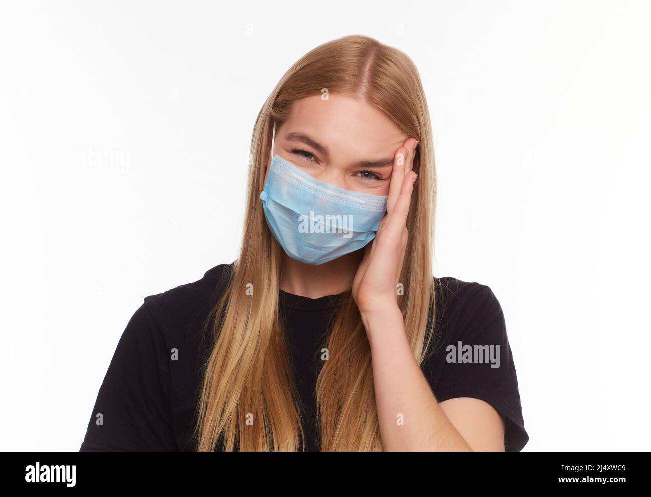 Studio portrait of young blonde illness girl with closed eyes, wearing ...