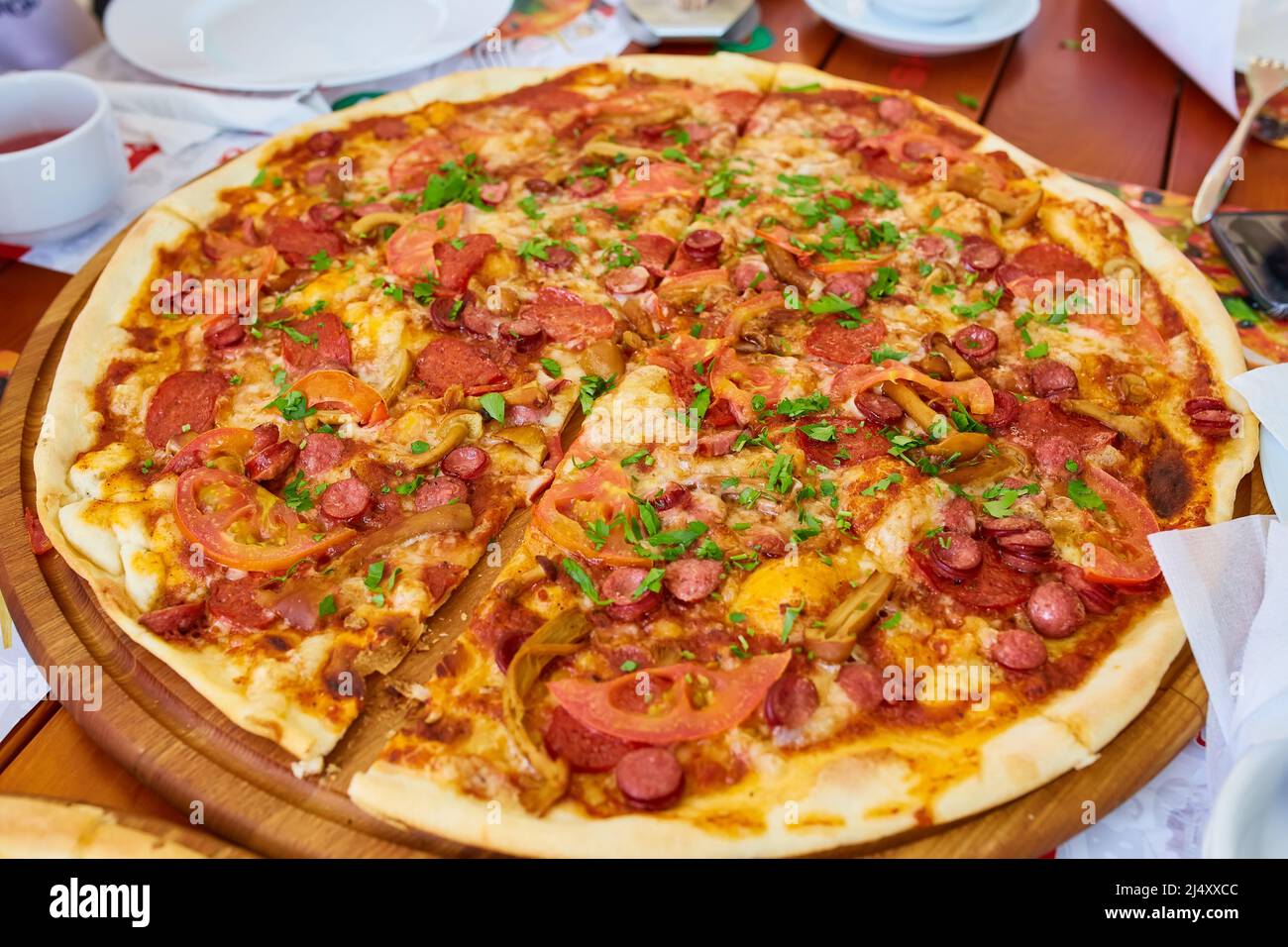 Side view on pizza with pepper and tomatoes Stock Photo - Alamy
