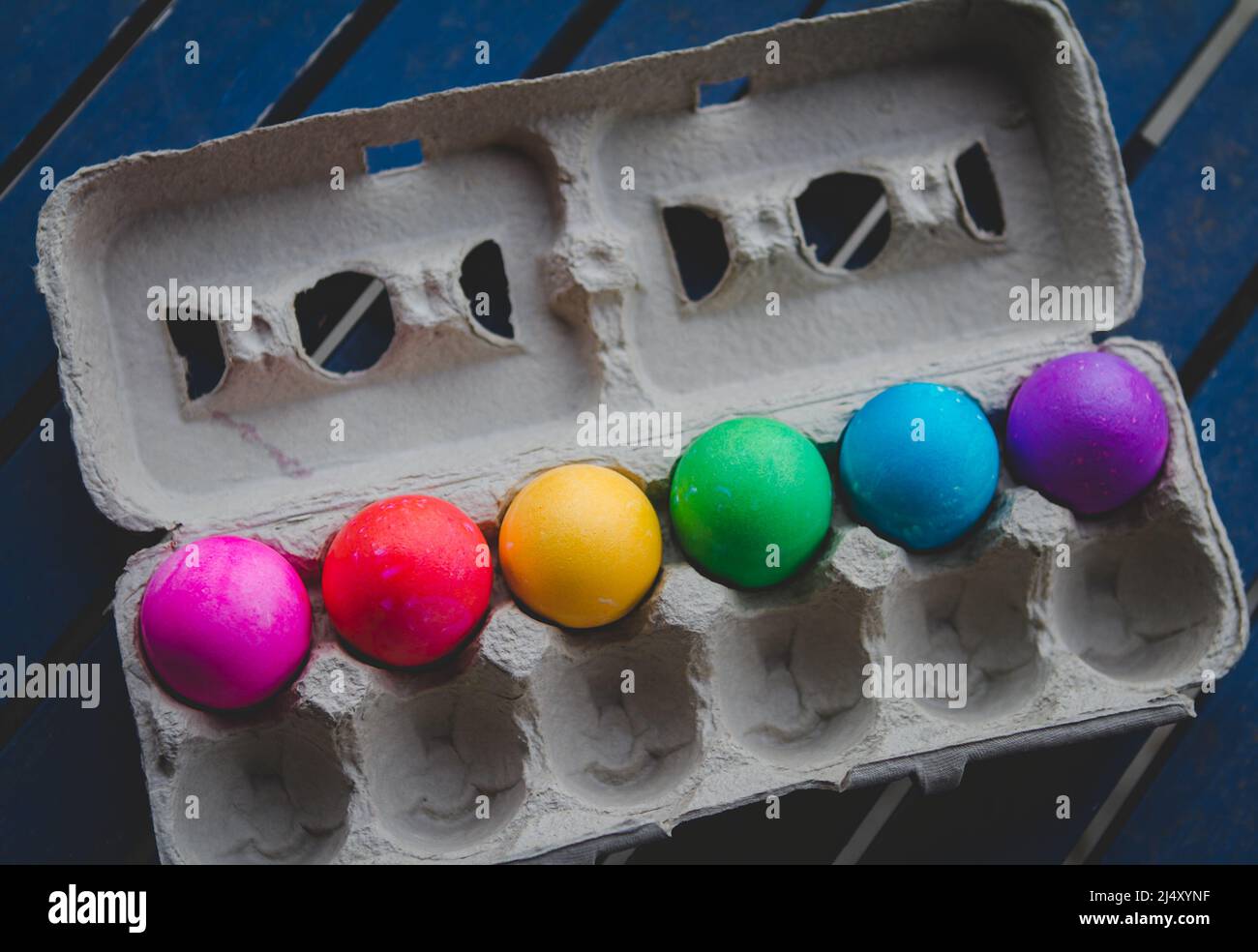 Bright rainbow colored dyed easter Eggs lined up in egg carton Stock ...