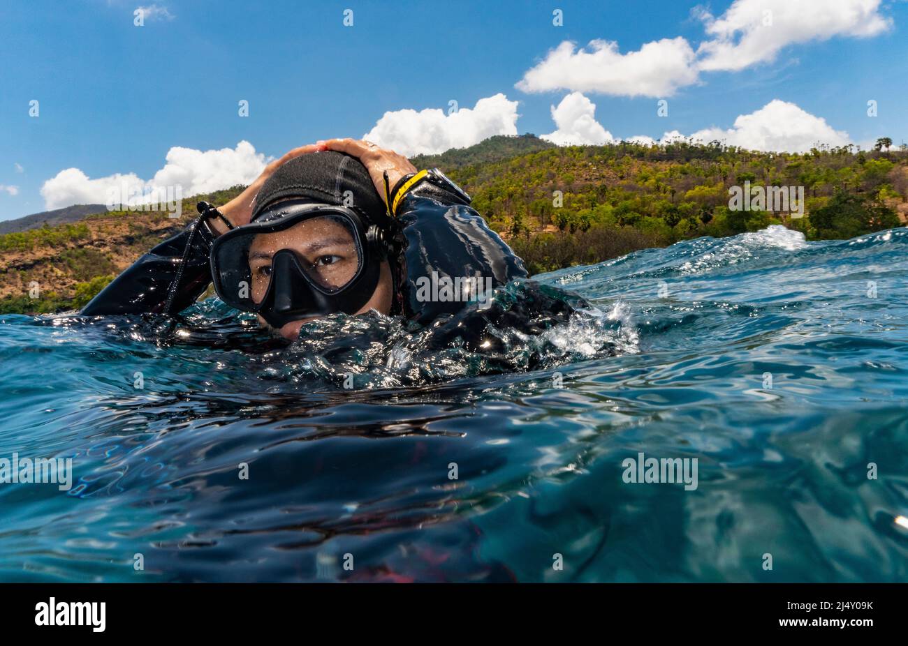 diver emerging out of the water around Bali Stock Photo - Alamy