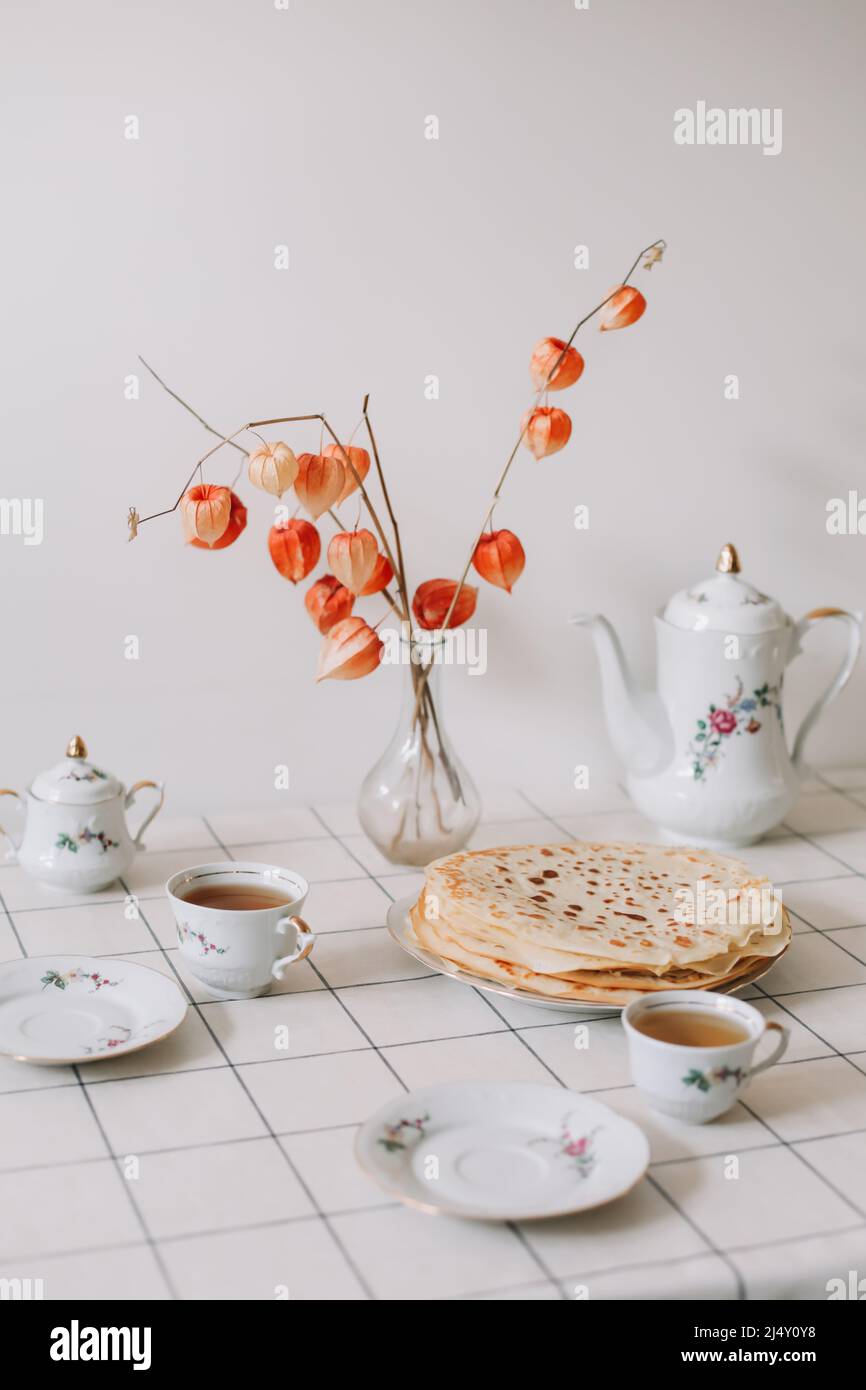 A set of porcelain coffee and tea set with cups, mugs and plates on a ...