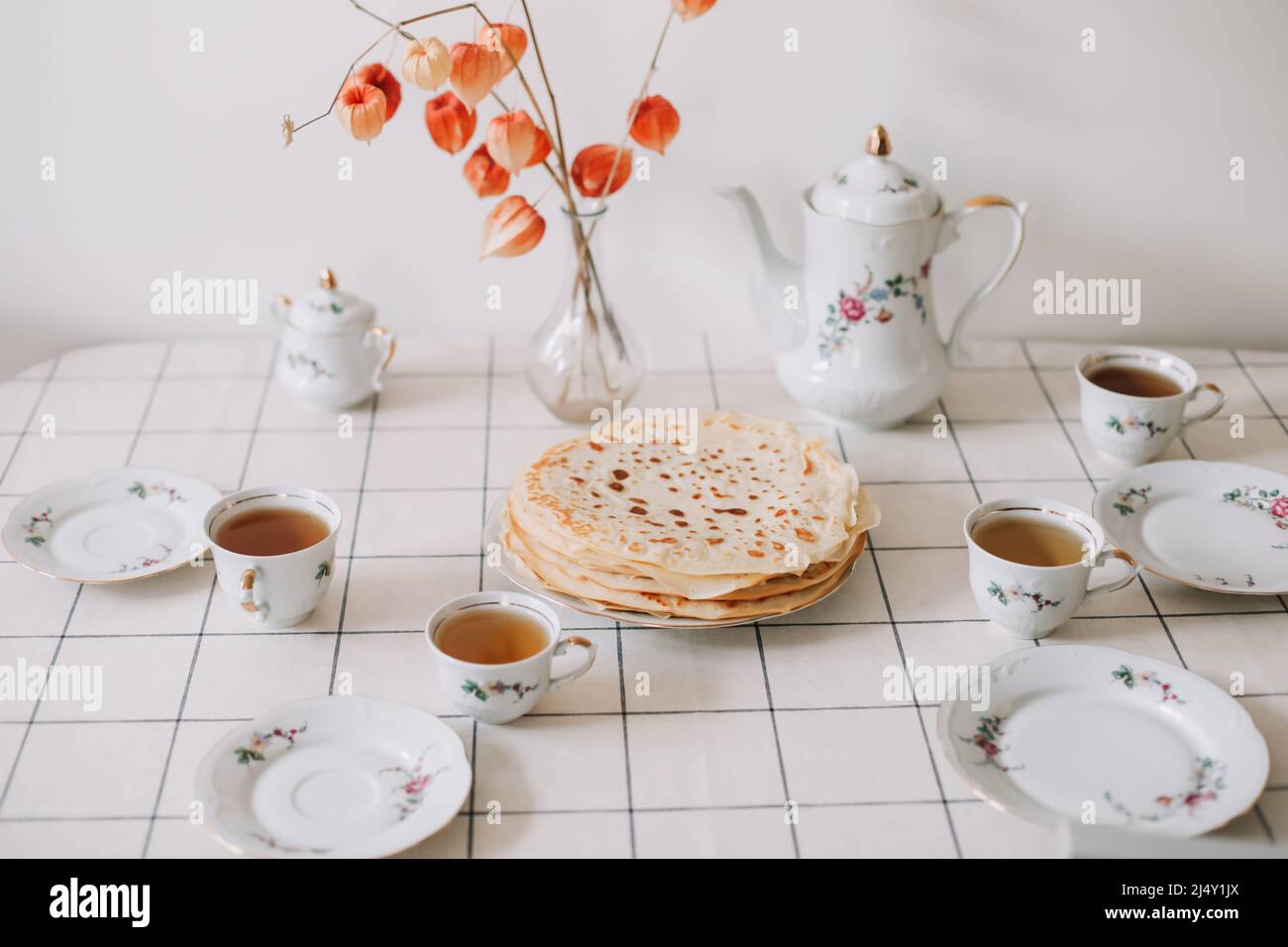 A set of porcelain coffee and tea set with cups, mugs and plates on a ...